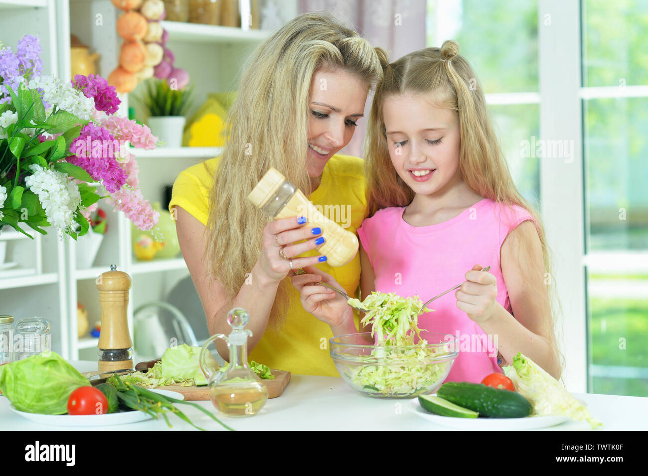 Portrait of smiling mother and daughter cooking together Stock Photo ...