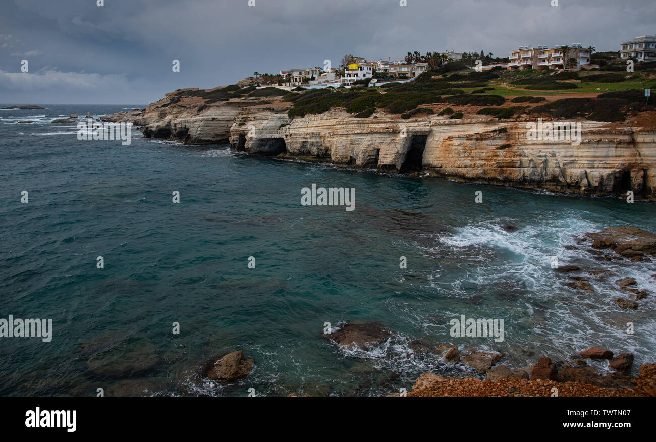 Panoramic view of the famous sea caves on the rocky coast of Peyia ...