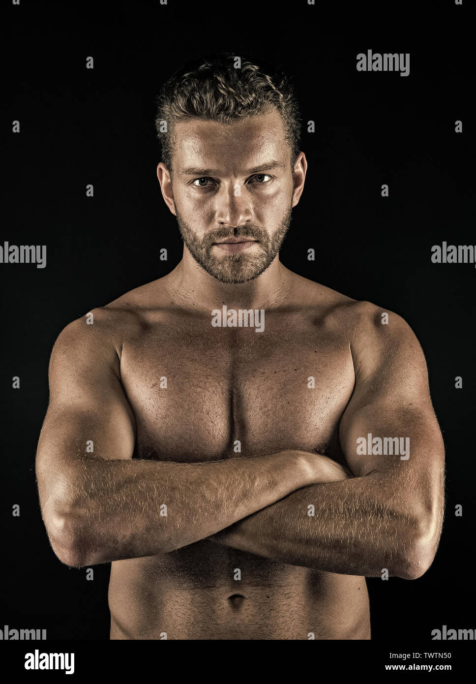 Athlete with folded hands on muscular bare torso, chest, belly, muscles ...