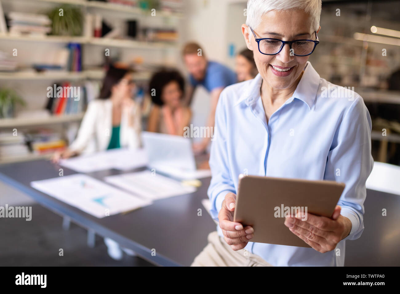 Group of successful business people at work in office Stock Photo - Alamy