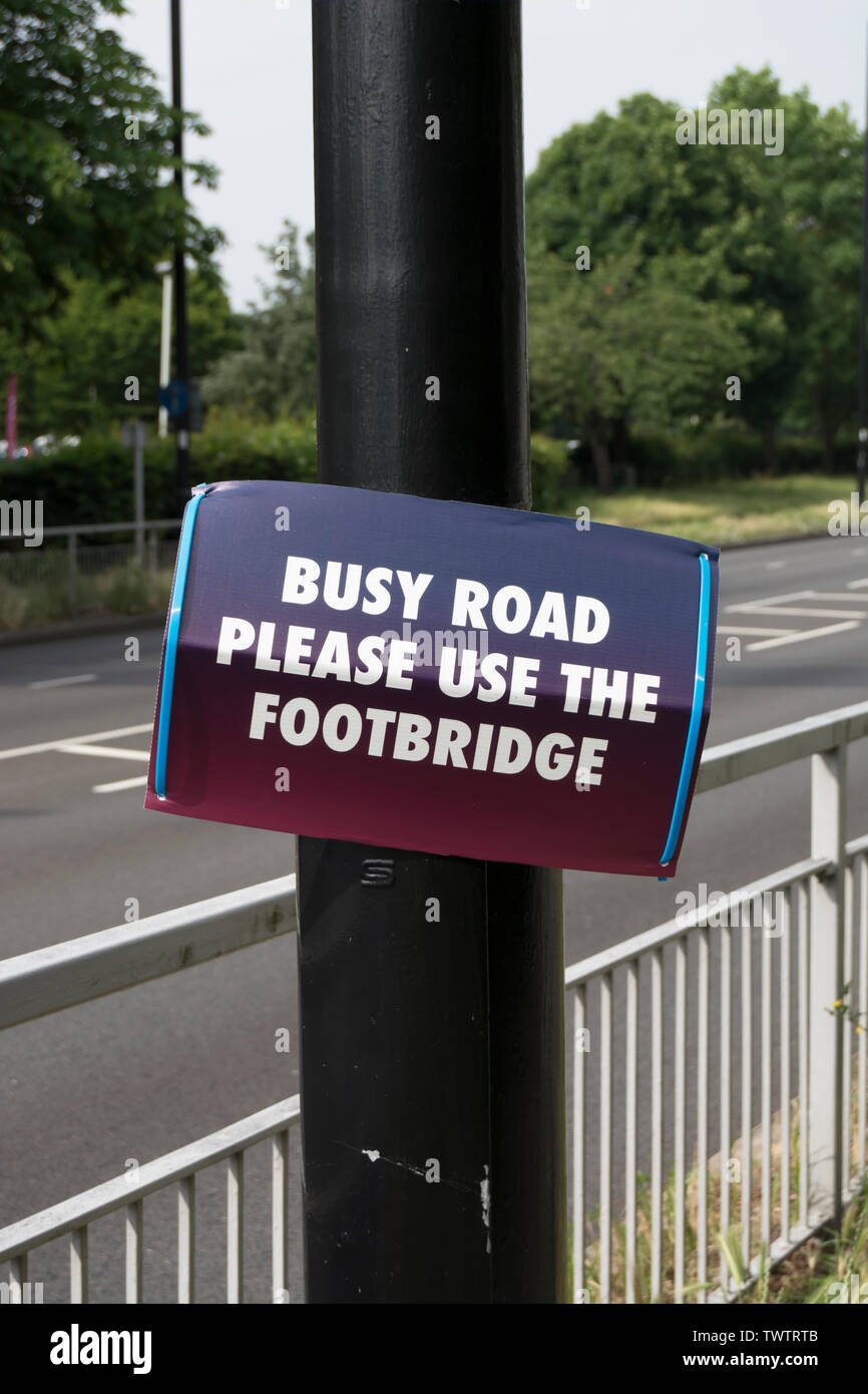 busy road use footbridge sign on the a316 in richmond, southwest london ...