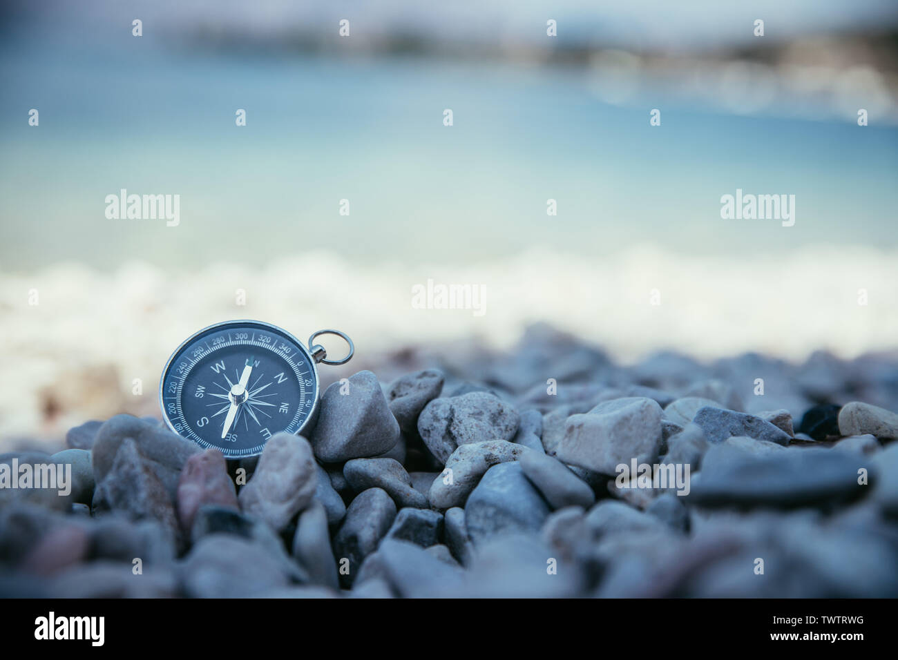 Navigation: close up of a compass lying on a pebble beach Stock Photo ...