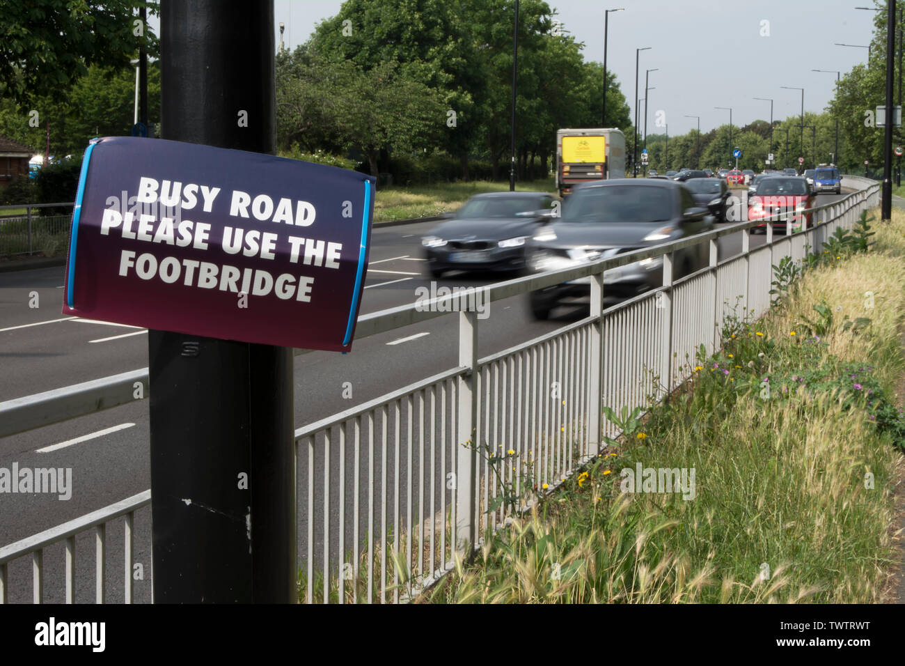 busy road use footbridge sign on the a316 in richmond, southwest london ...