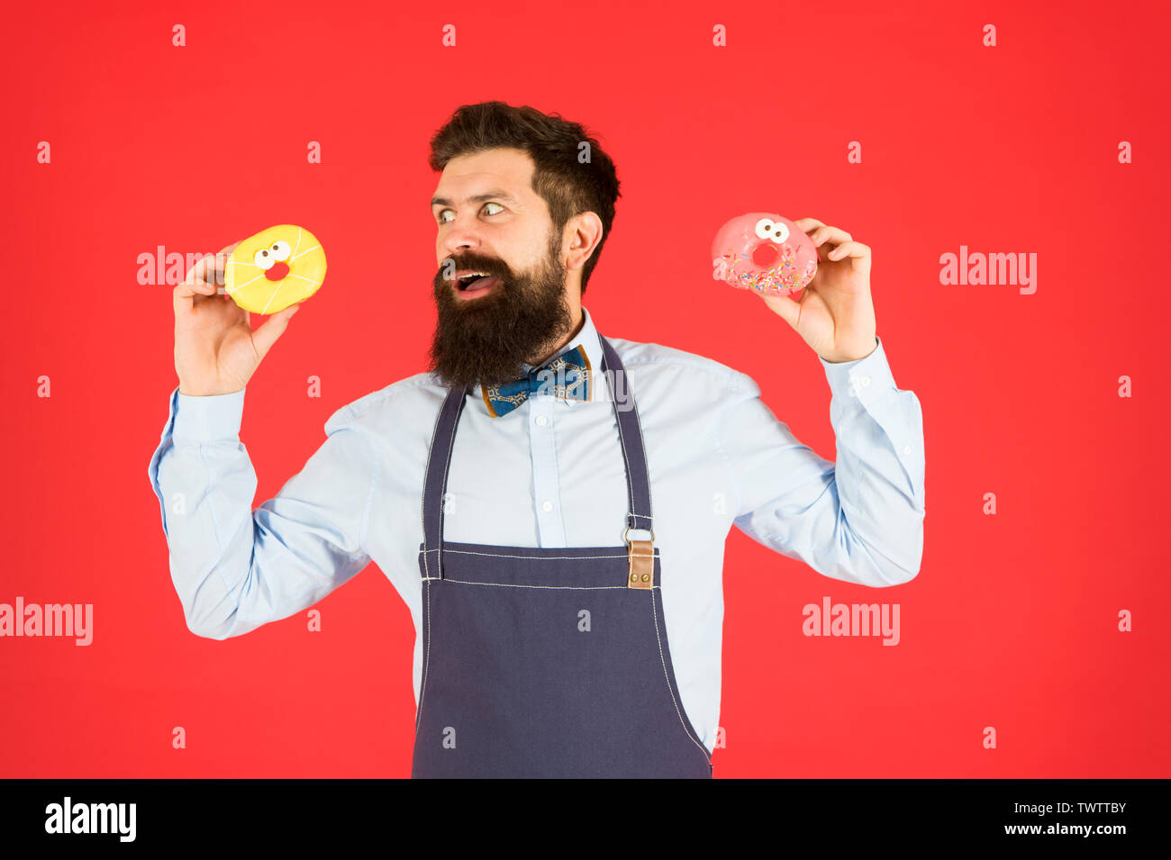 Glazed donut. Bearded well groomed man in apron selling donuts. Donut ...
