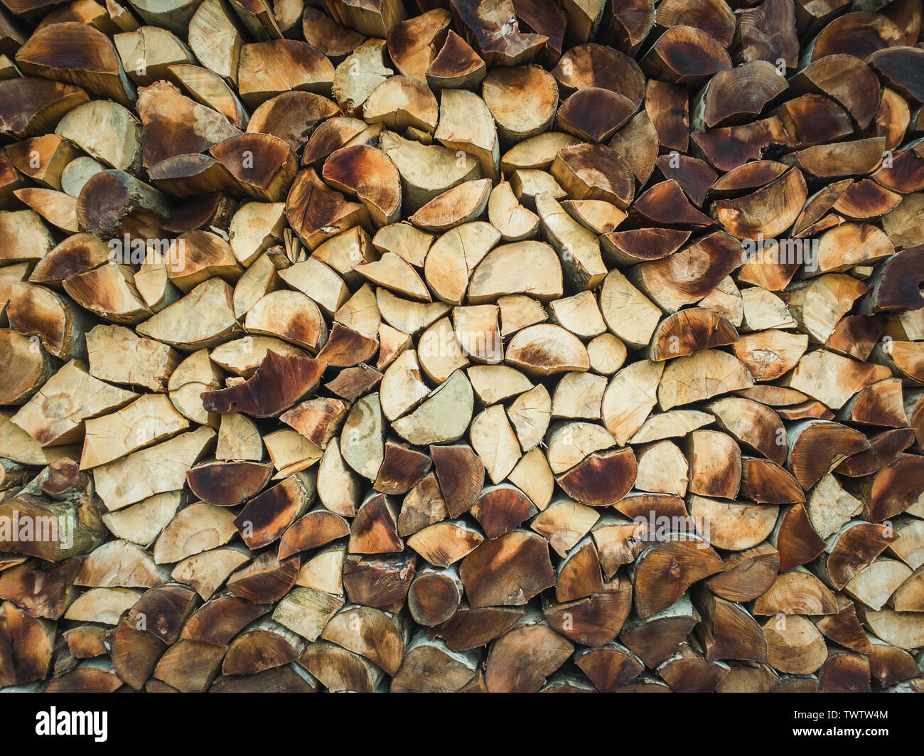 Closeup pattern of a stack of split logs, old dusty firewood. Pile ...