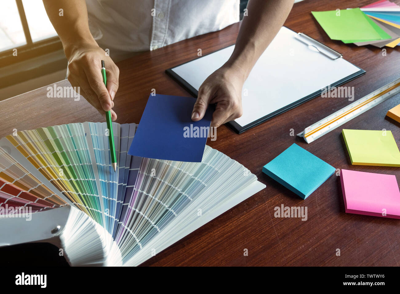 Graphic designer choose colors from the color bands samples for design ...