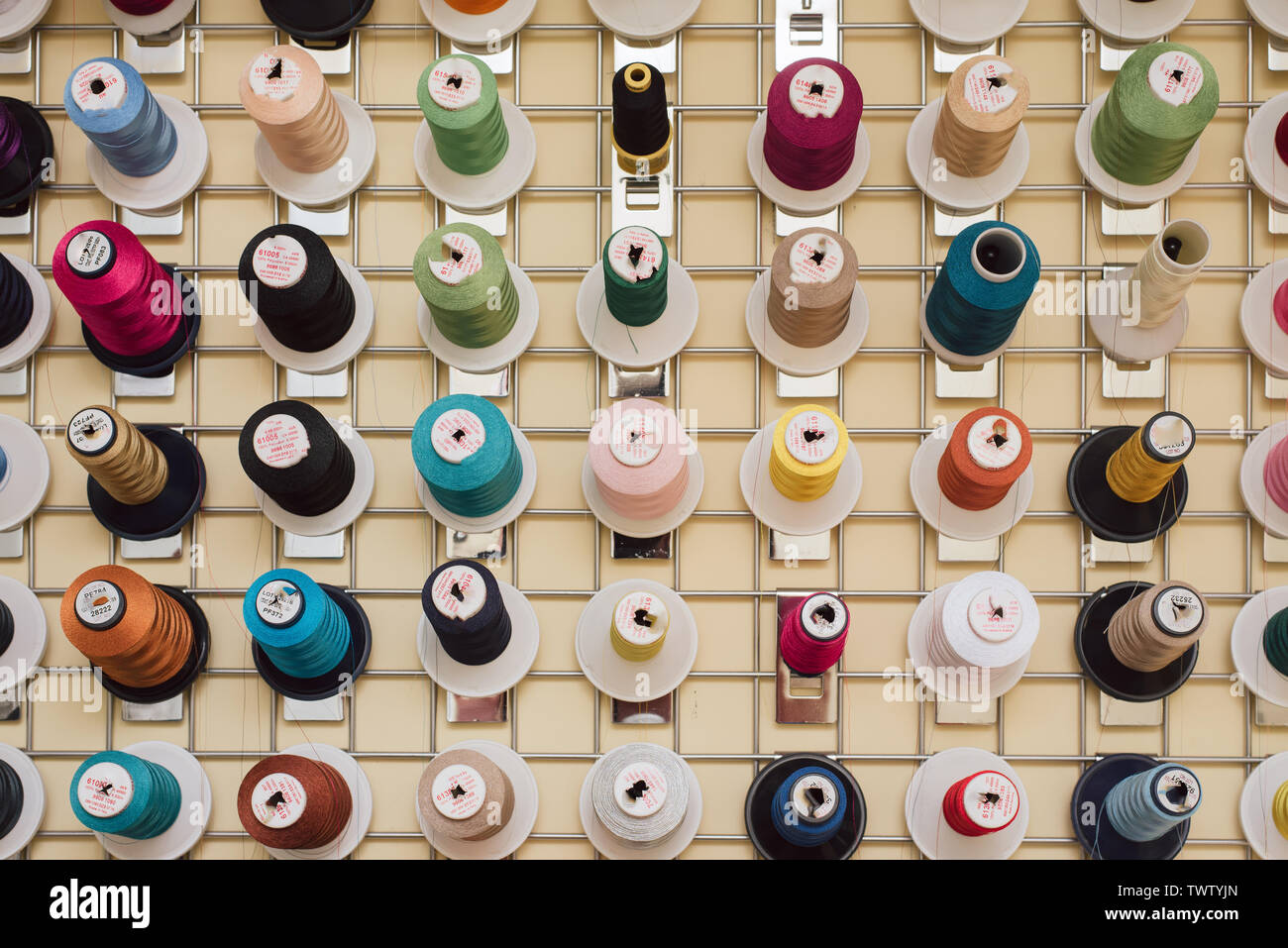 Spools of thread hanging in a tailor shop. Skeins for sewing machine ...