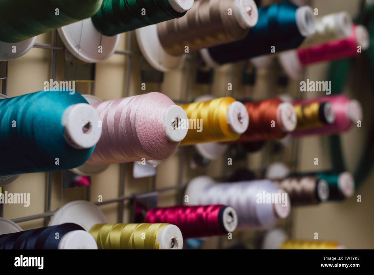 Spools of thread hanging in a tailor shop. Skeins for sewing machine ...