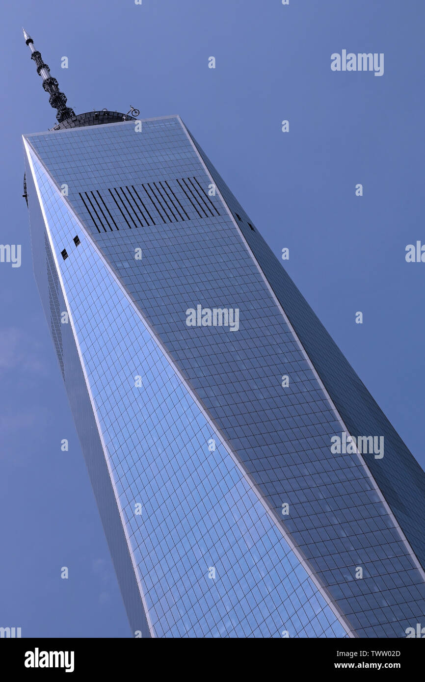 Tall modern skyscraper building with blue glass facade and antenna on ...