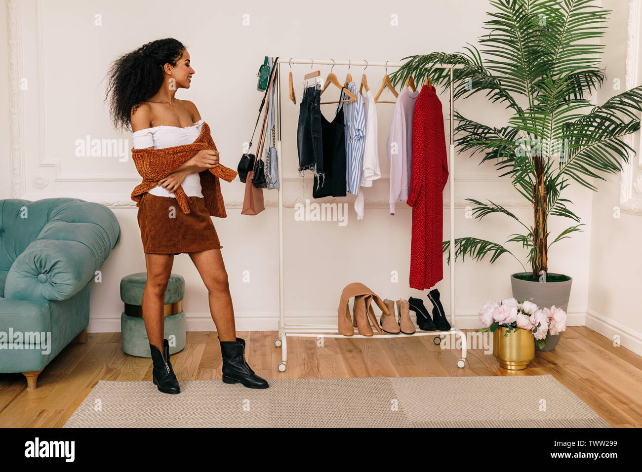 Side view of a professional buyer looking on clothes rack Stock Photo ...