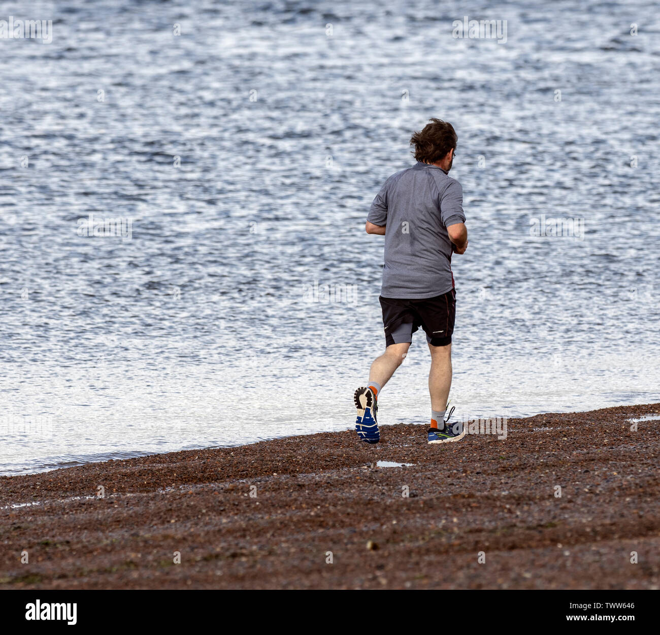 Black man jogging beach hi-res stock photography and images - Alamy