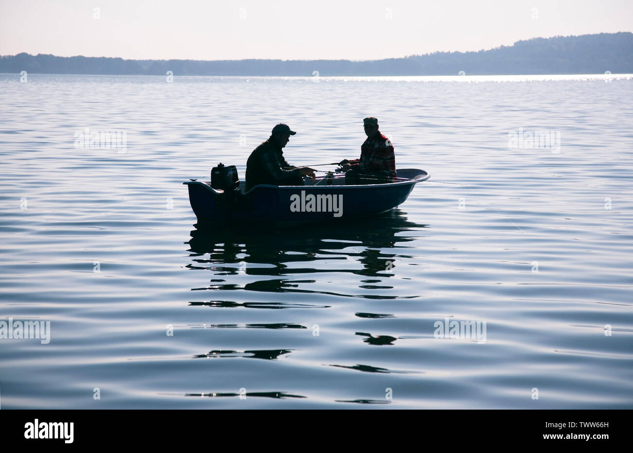 Two men fishing from a boat Stock Photo - Alamy