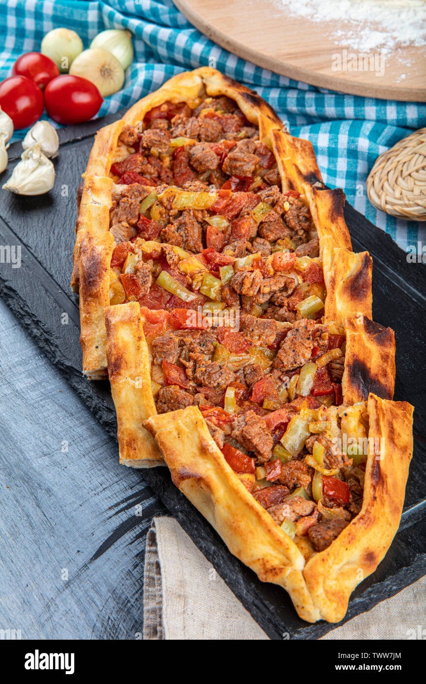 Traditional Turkish Cuisine; pide with cubed meat / kusbasili pide ...