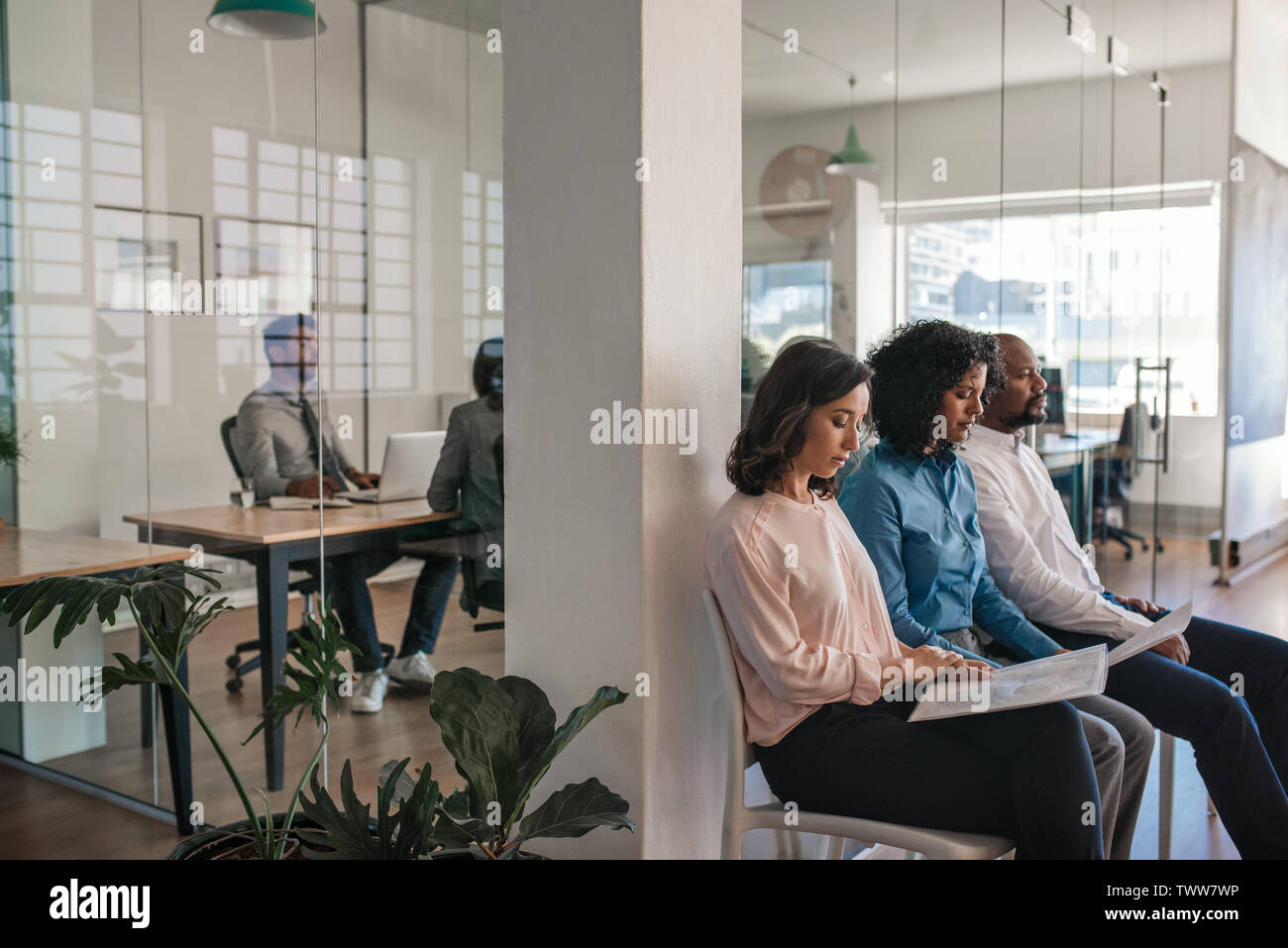 Applicants waiting outside of a manager's office before their ...