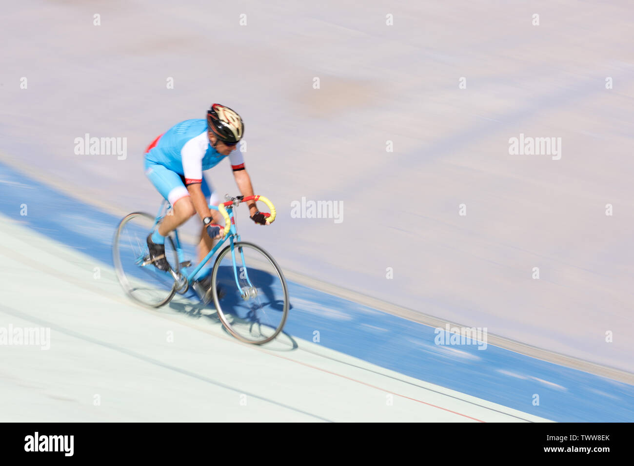 Senior citizen riding a bicycle around a velodrome Stock Photo - Alamy