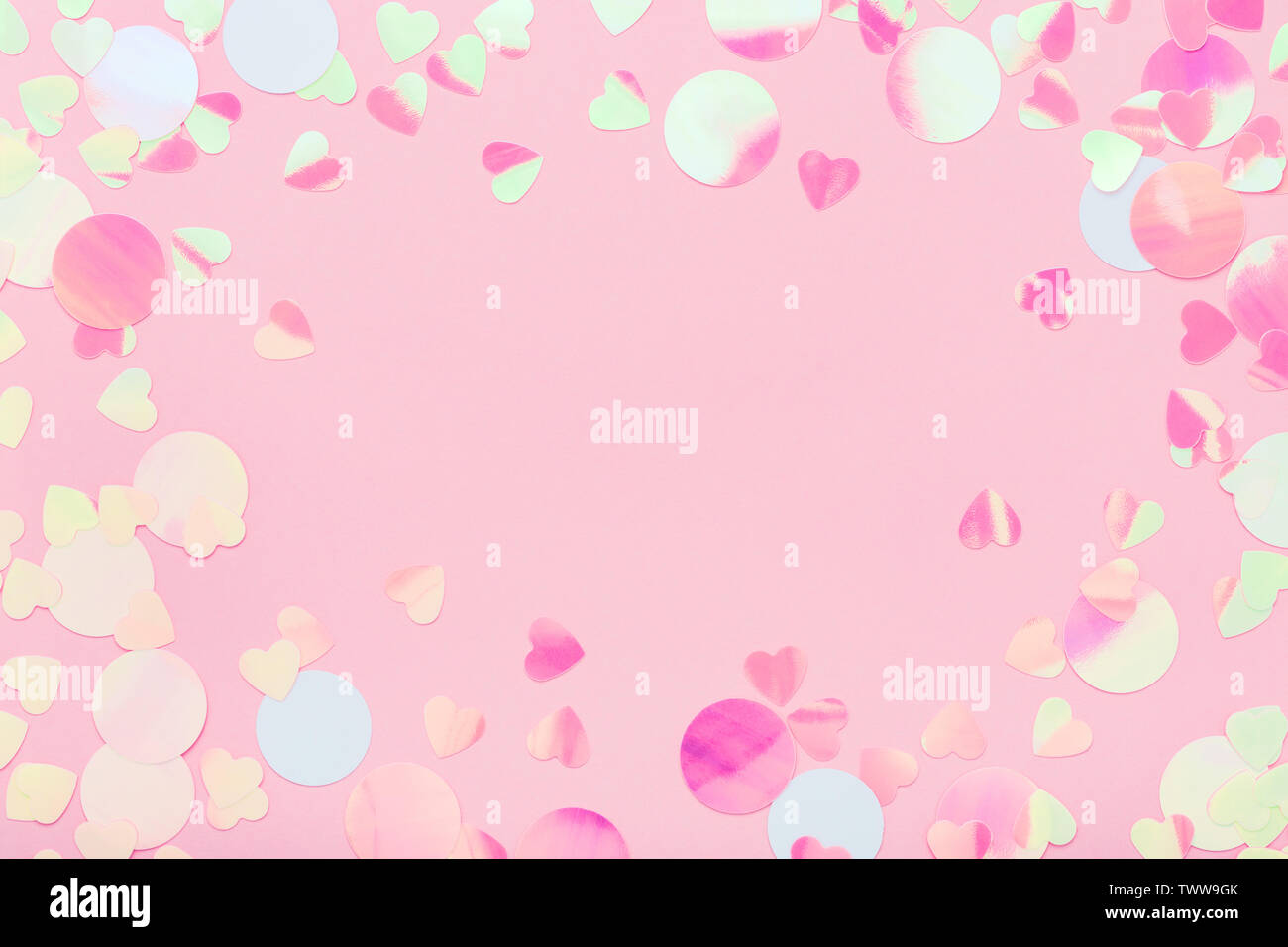 Festive frame of iridescent multicolored confetti sparkling on pink ...