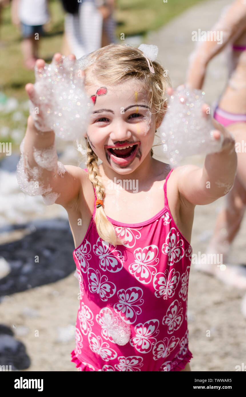 happy girl enjoying foam party Stock Photo - Alamy
