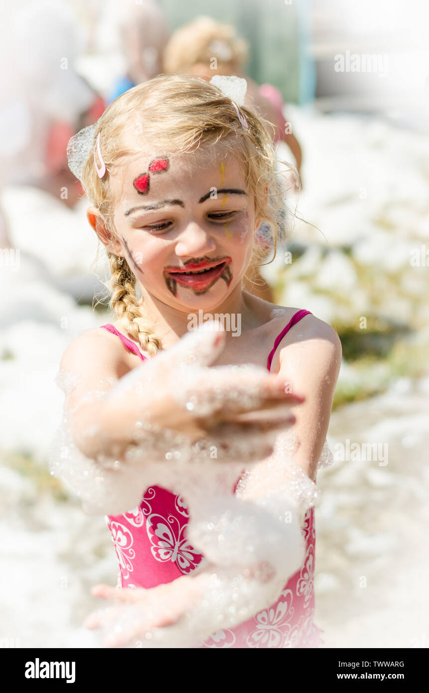 happy girl enjoying foam party Stock Photo - Alamy