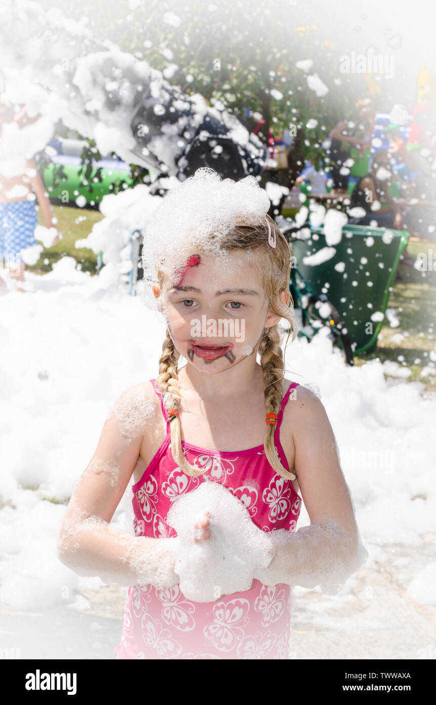happy blond girl covered by white foam Stock Photo - Alamy