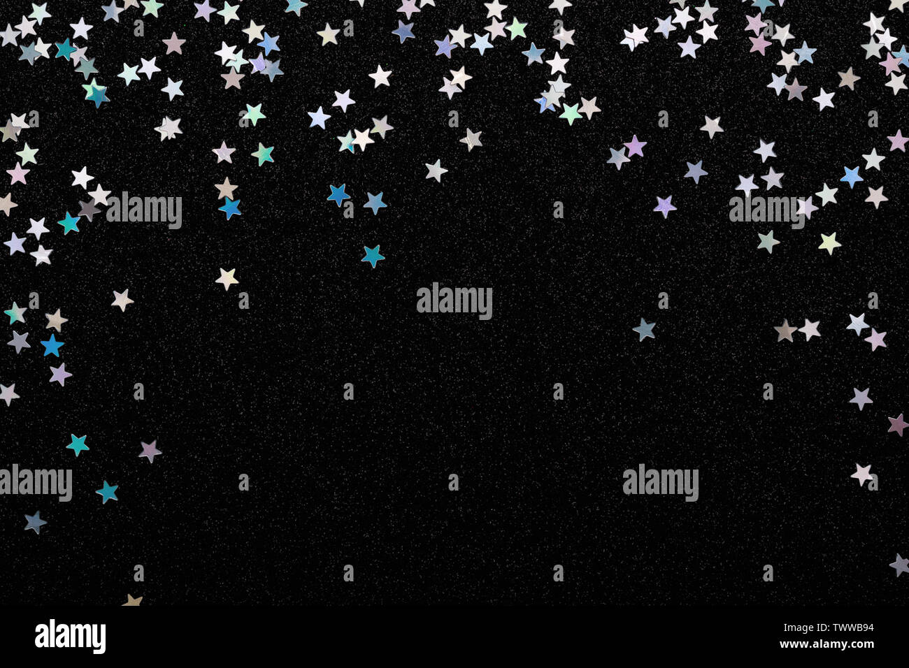 Iridescent Silver Stars Confetti On Black Festive Background Glowing