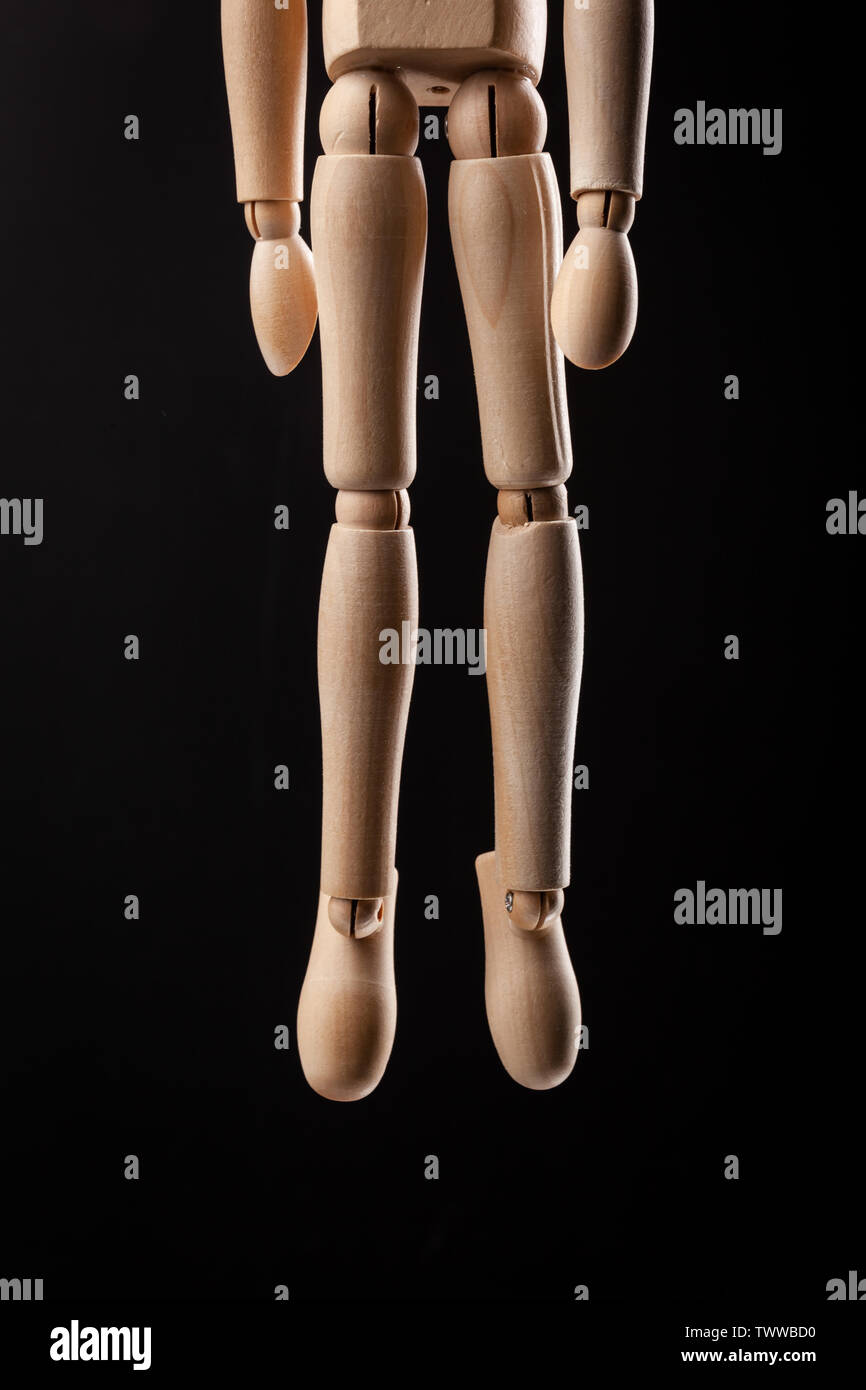 Wood figure hanged with a rope Isolated on black background, emotional ...