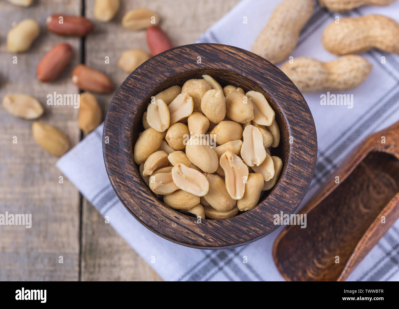 Peanuts in small dark wooden bowl on natural rustic desk Stock Photo ...