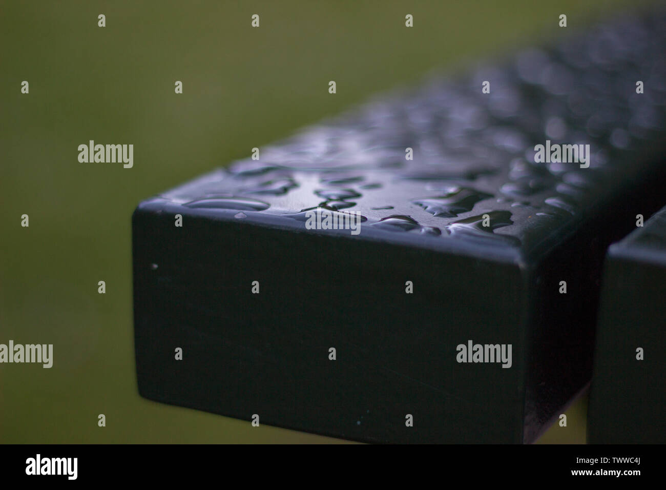 Close up of water drops on a park bench Stock Photo - Alamy