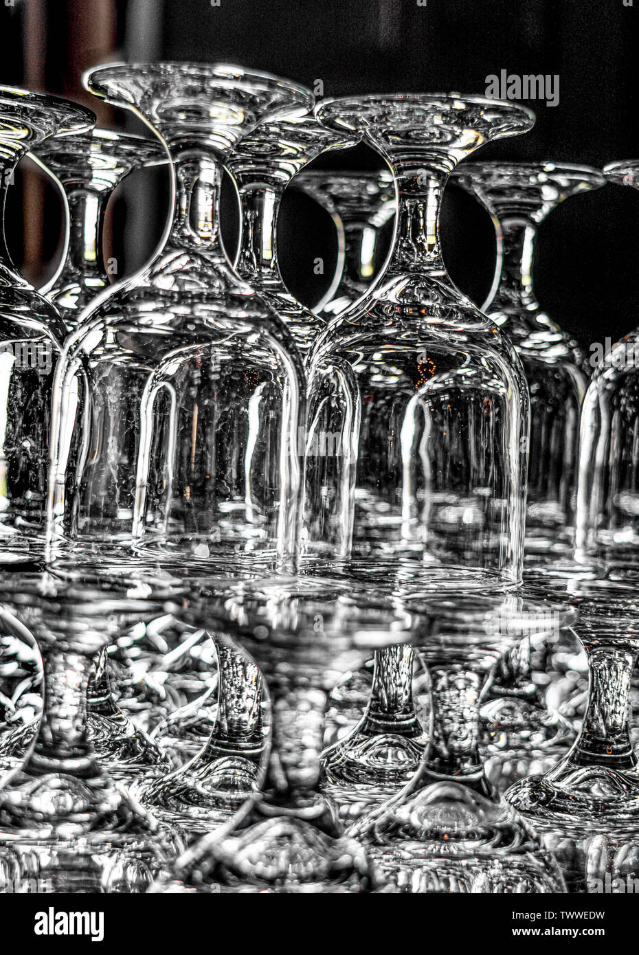 dozens of glasses stacked up at a bar at a wedding event in a hotel ...