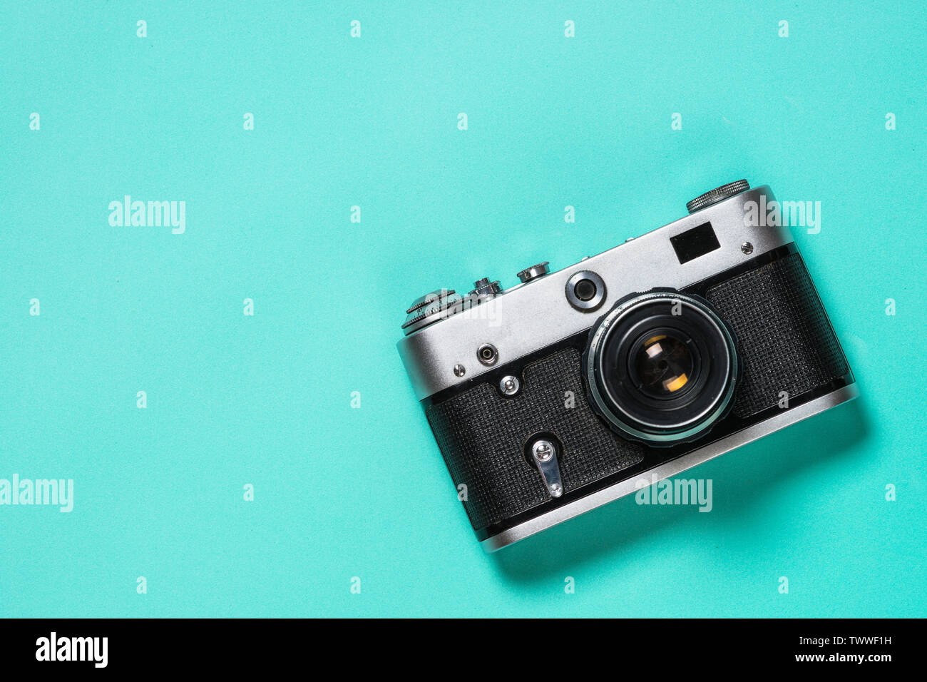Old film camera on turquoise background Stock Photo - Alamy
