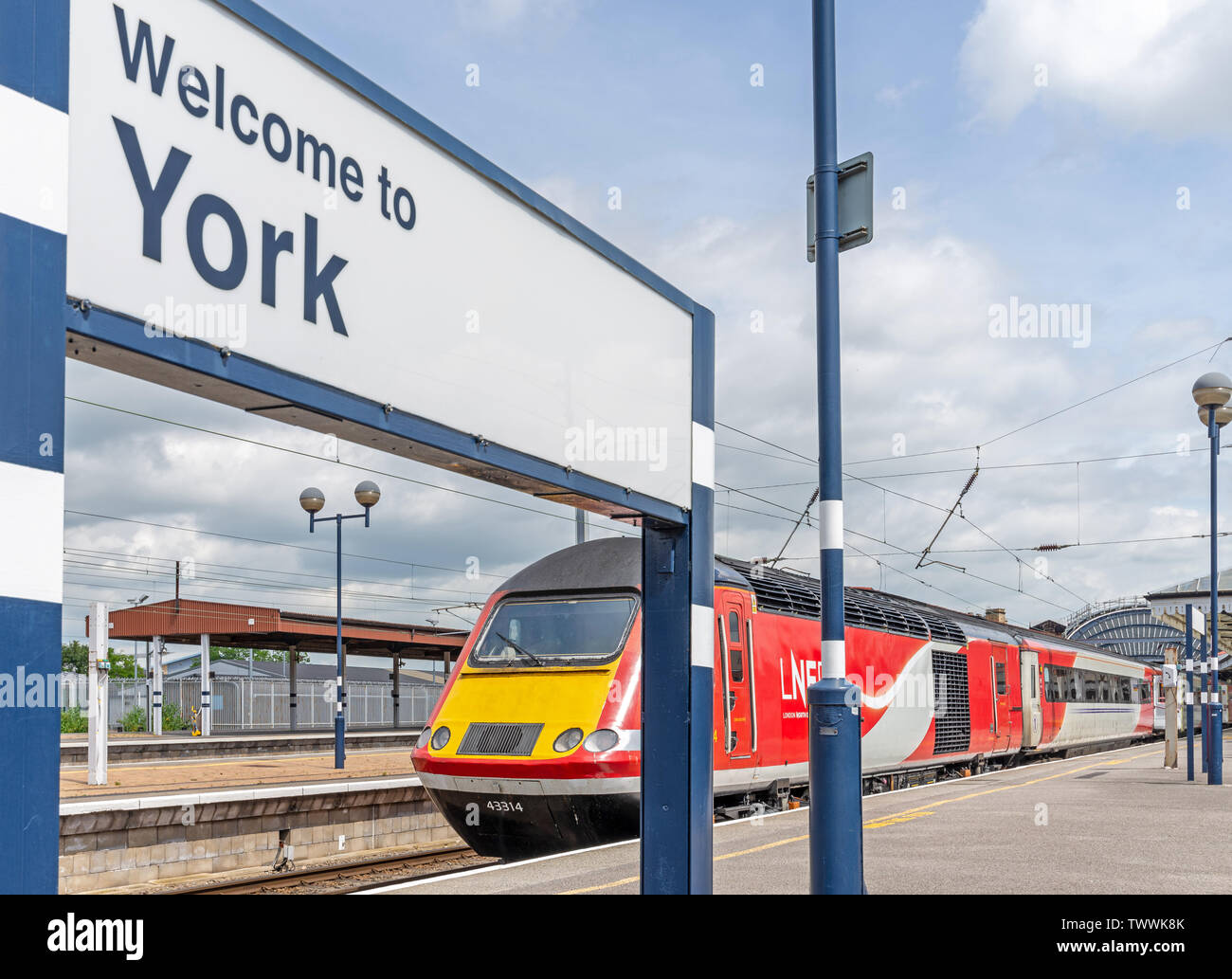 Train engine at a platform at York Station. A station sign is in front ...