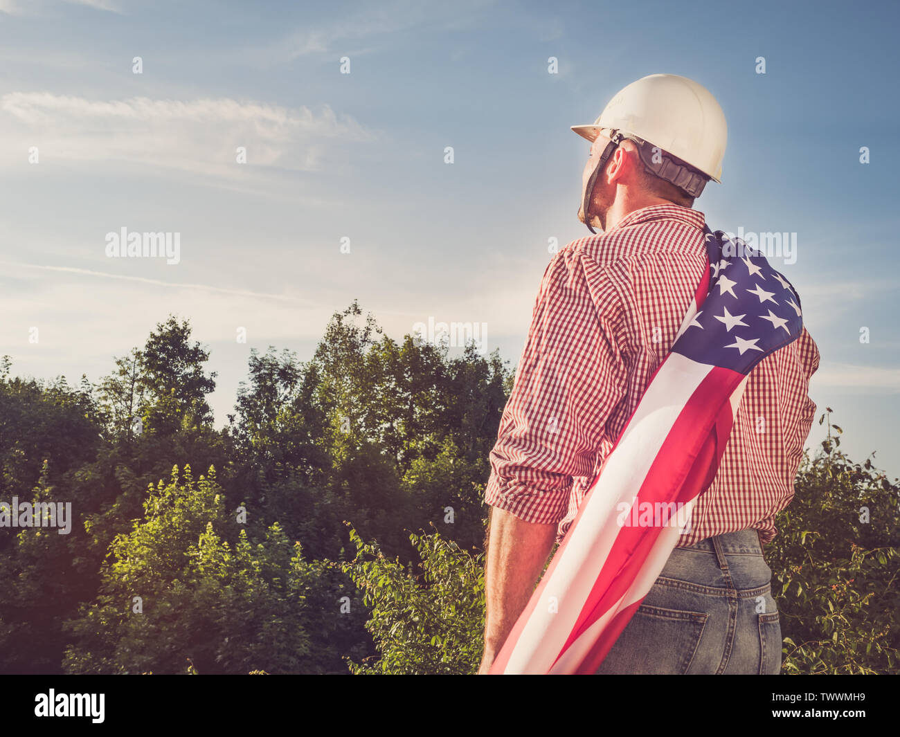 Engineer in a white helmet and American Flag Stock Photo - Alamy