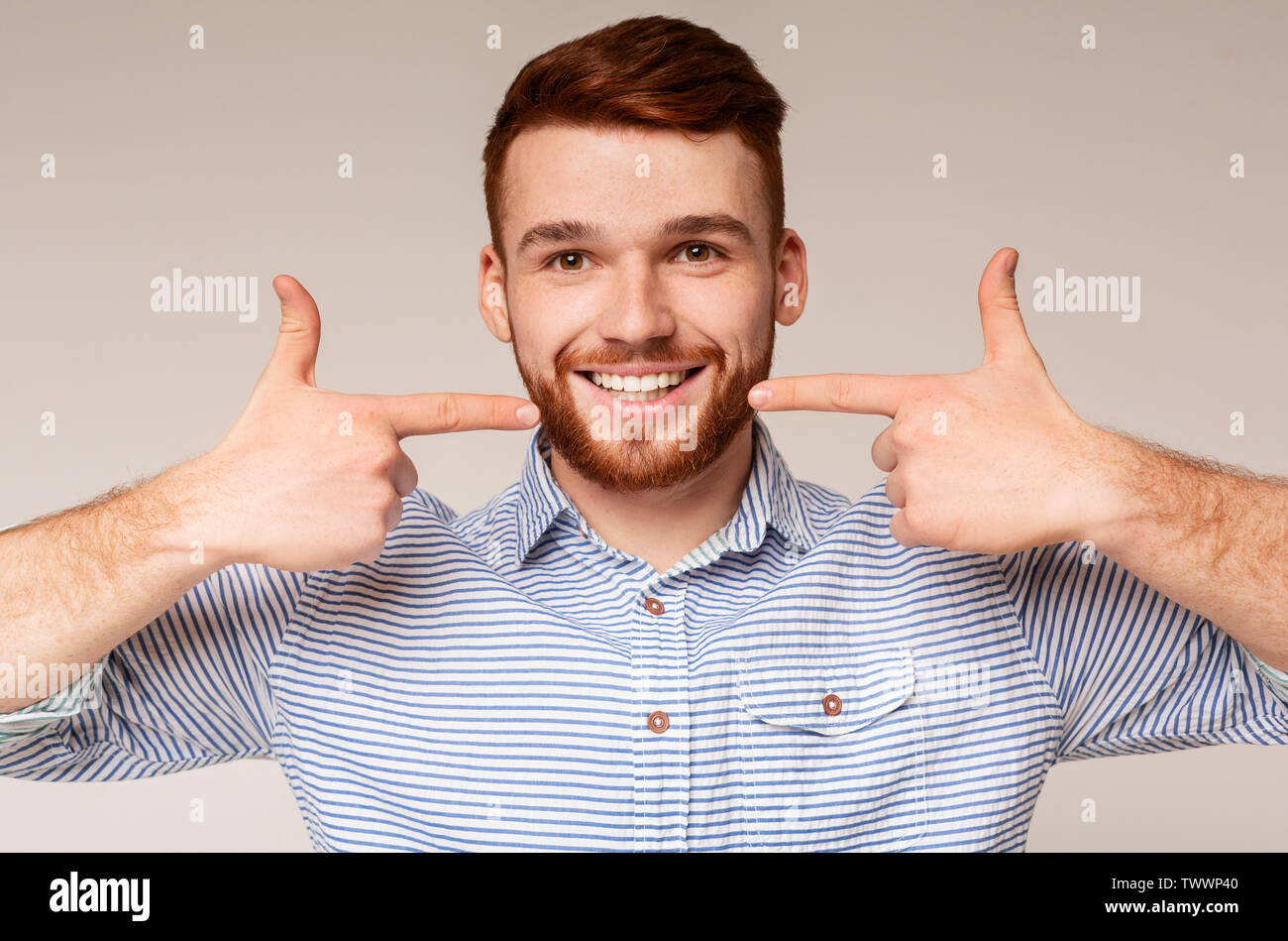 Young millennial man showing his beautiful smile Stock Photo - Alamy