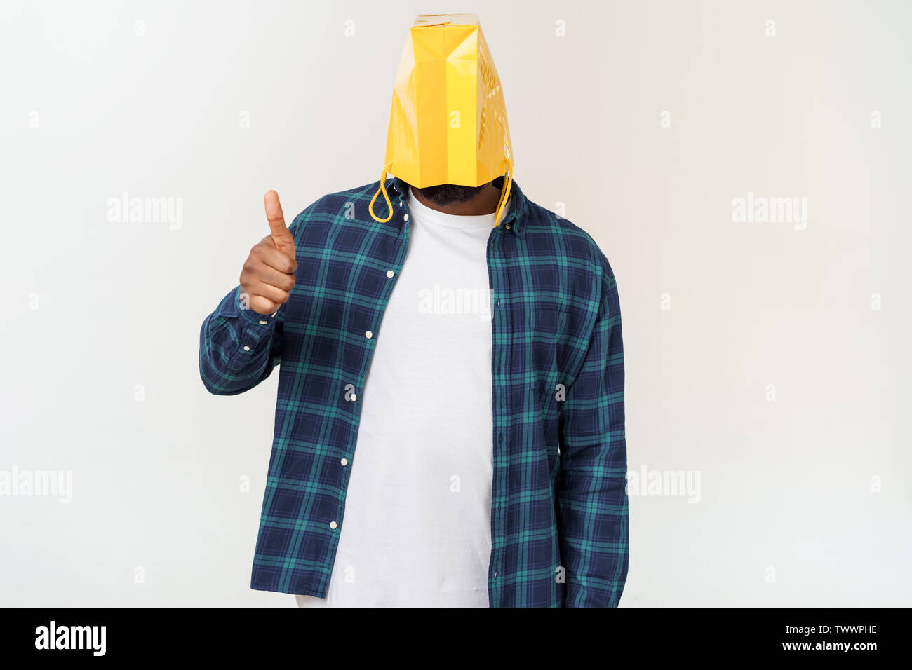 Man in paper bag on head showing with forefingers isolated on white ...