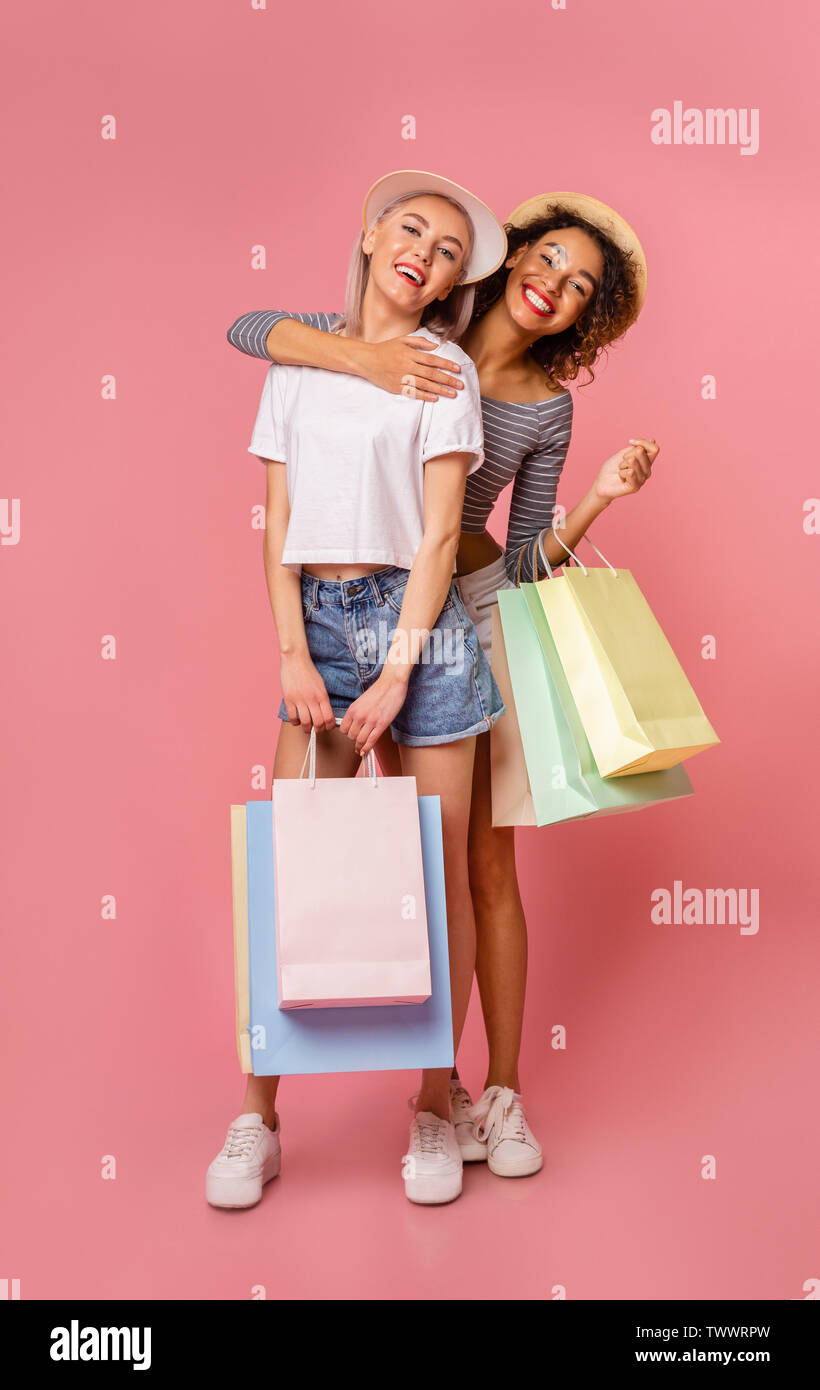 Stylish millennial women enjoying summer shopping with paper bags Stock ...
