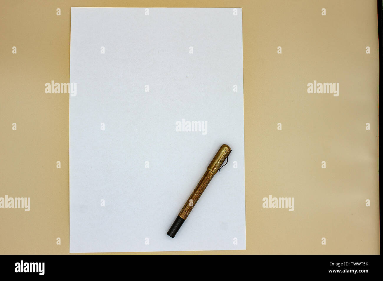Naples Italy. On a white sheet, an old gold fountain pen. The pen dates ...