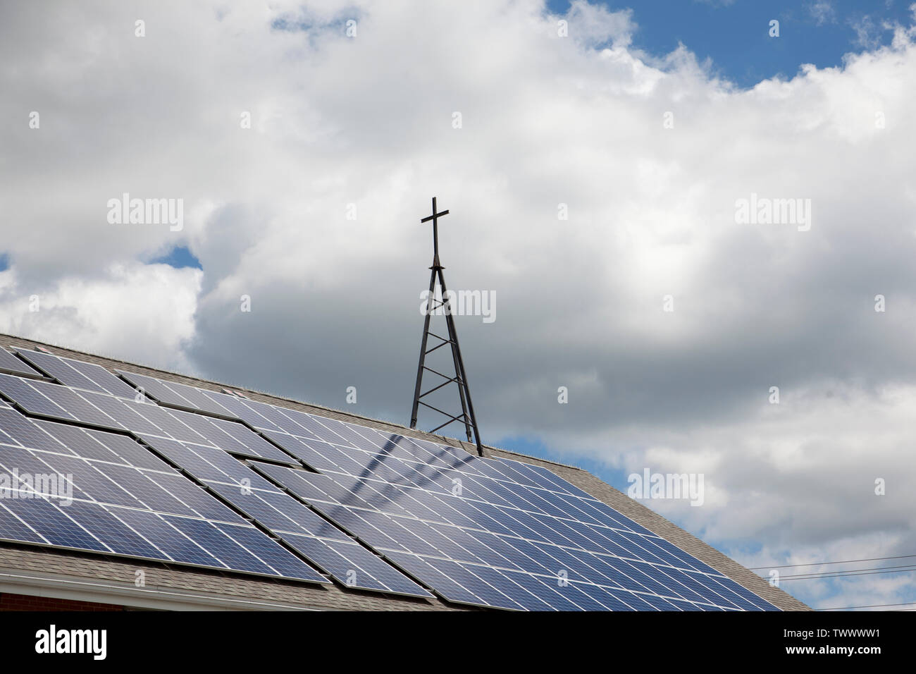 A church using renewable energy, with solar panels mixed in with a sign ...