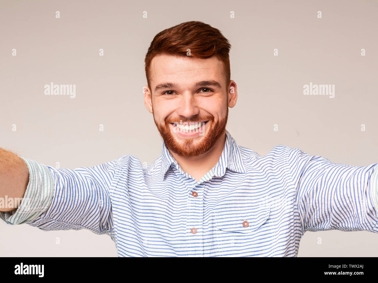 Cheerful guy holding model hi-res stock photography and images - Alamy