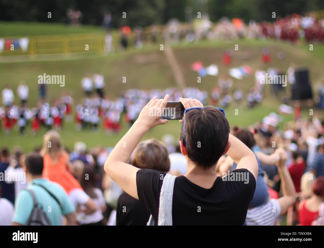 Woman taking photo of live stage performance Stock Photo - Alamy