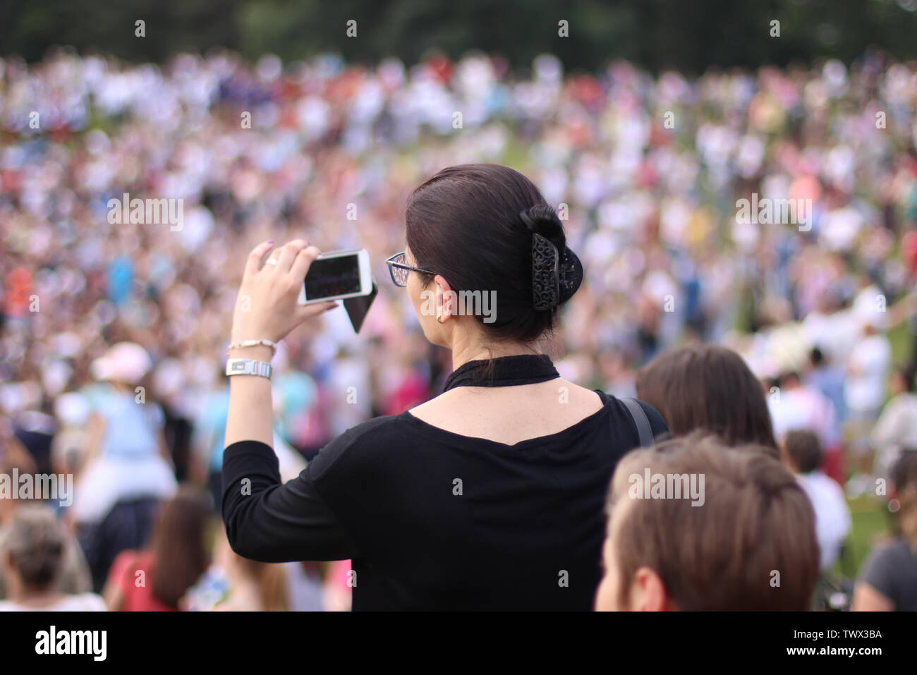 Woman taking photo of live stage performance Stock Photo - Alamy