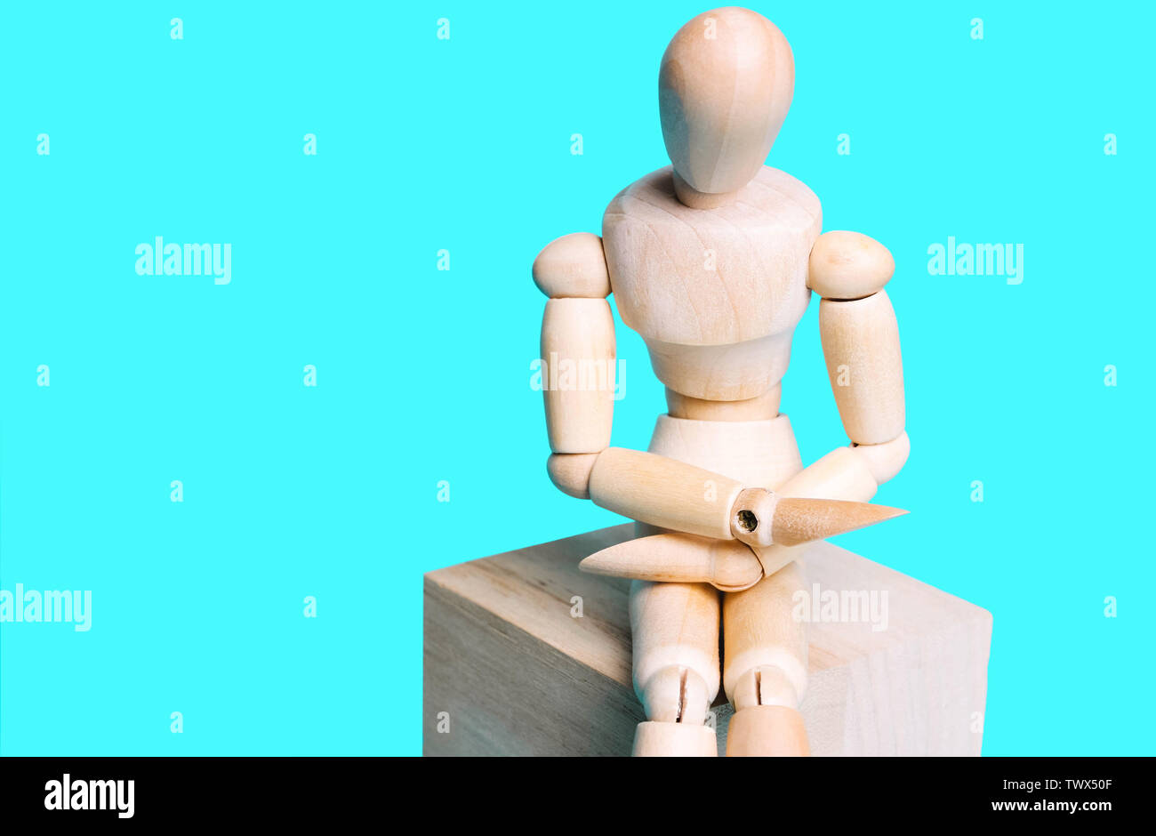 Wooden human figure on a blue background. Concept of abdominal pain ...