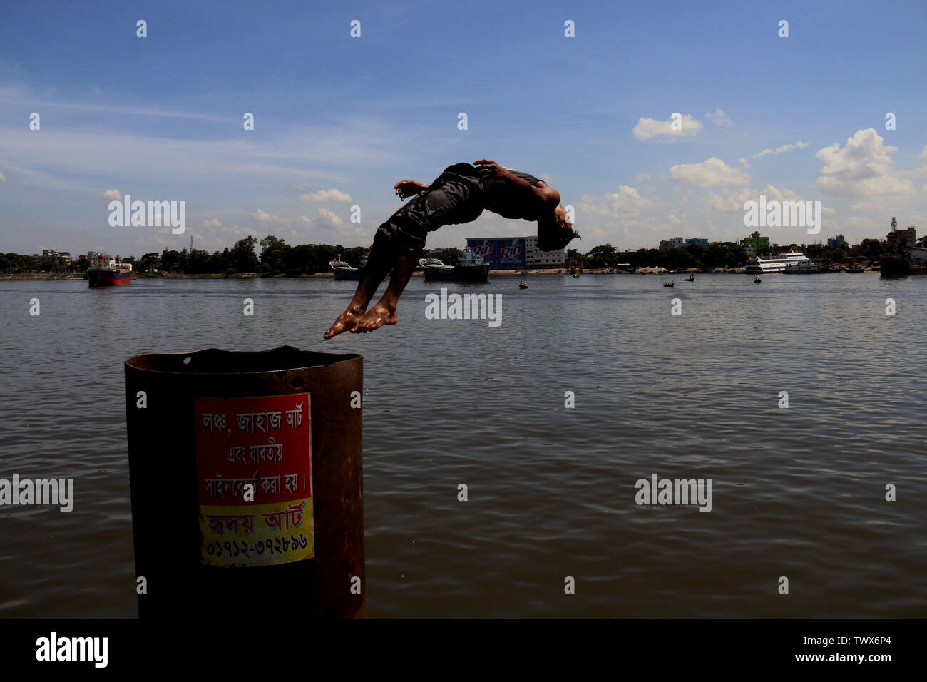 Dhaka, Bangladesh. 23rd June, 2019. Bangladeshi youth dives into ...