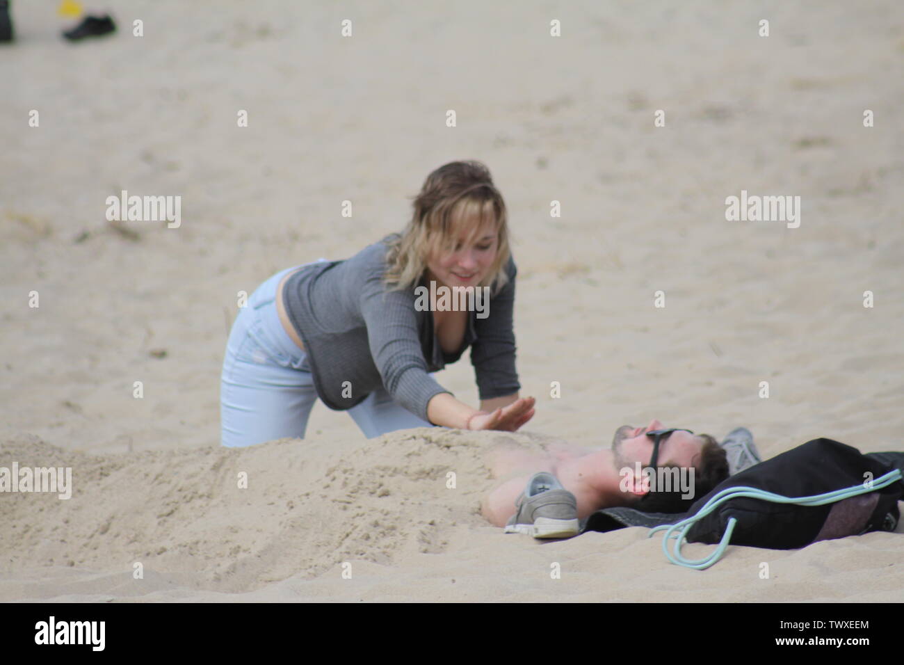 Woman buried in sand beach hi-res stock photography and images - Alamy