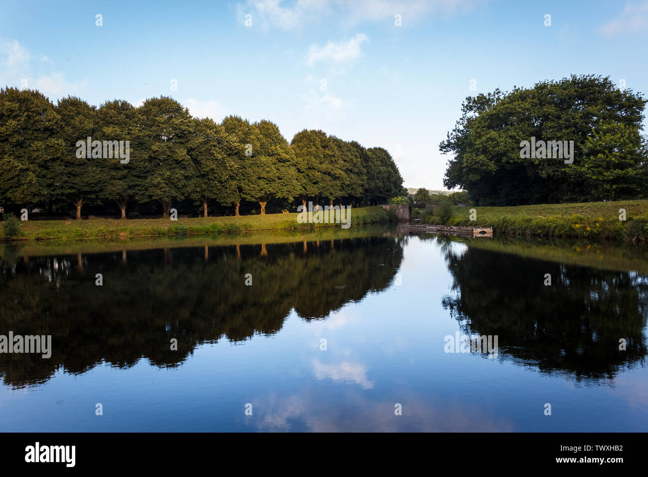 Beautiful mirror image of trees on the water of a river in Brittany ...