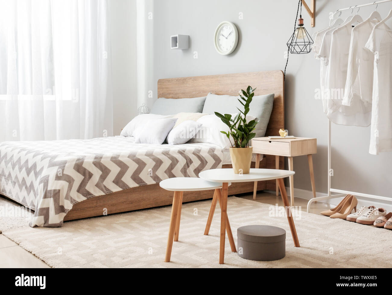 Table with plant in pot in interior of bedroom Stock Photo - Alamy