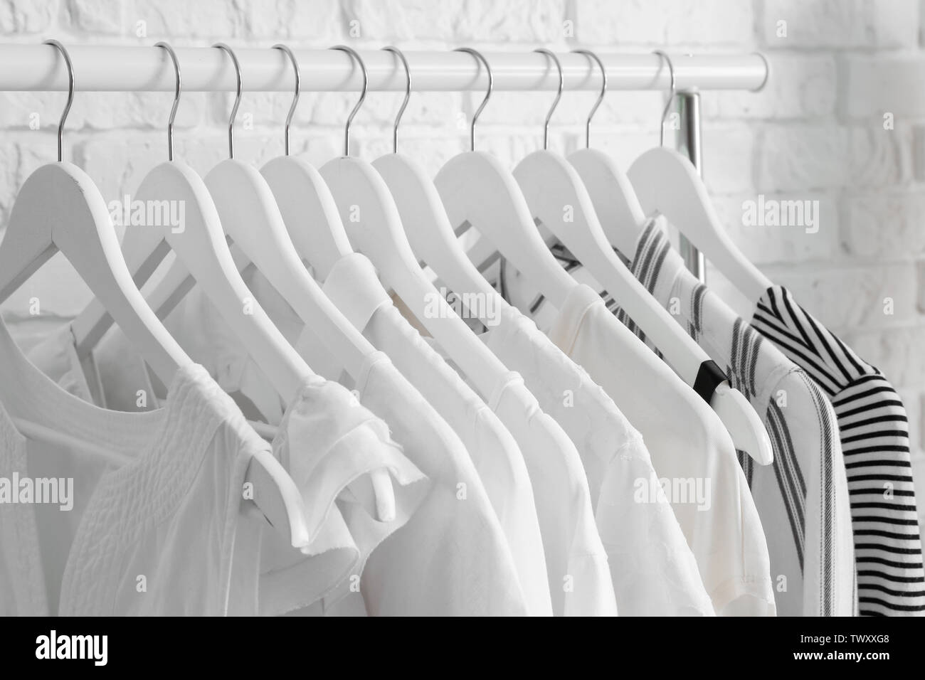 Rack with clean clothes in dressing room Stock Photo - Alamy