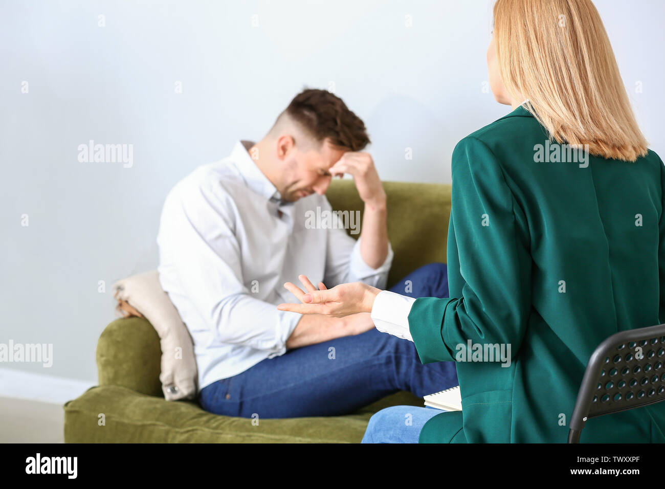 Psychologist working with man in office Stock Photo - Alamy