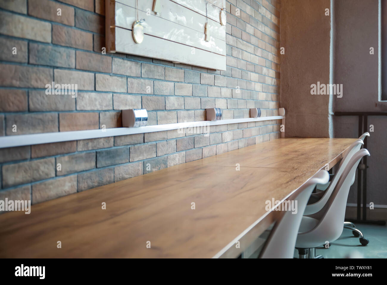 Big wooden table in interior of modern office Stock Photo - Alamy