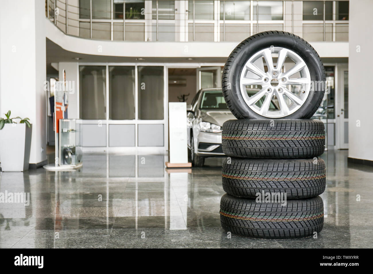 Tires in modern car showroom Stock Photo - Alamy