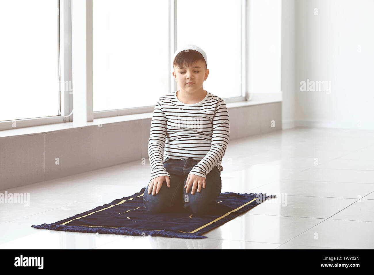 Little Muslim boy praying indoors Stock Photo - Alamy