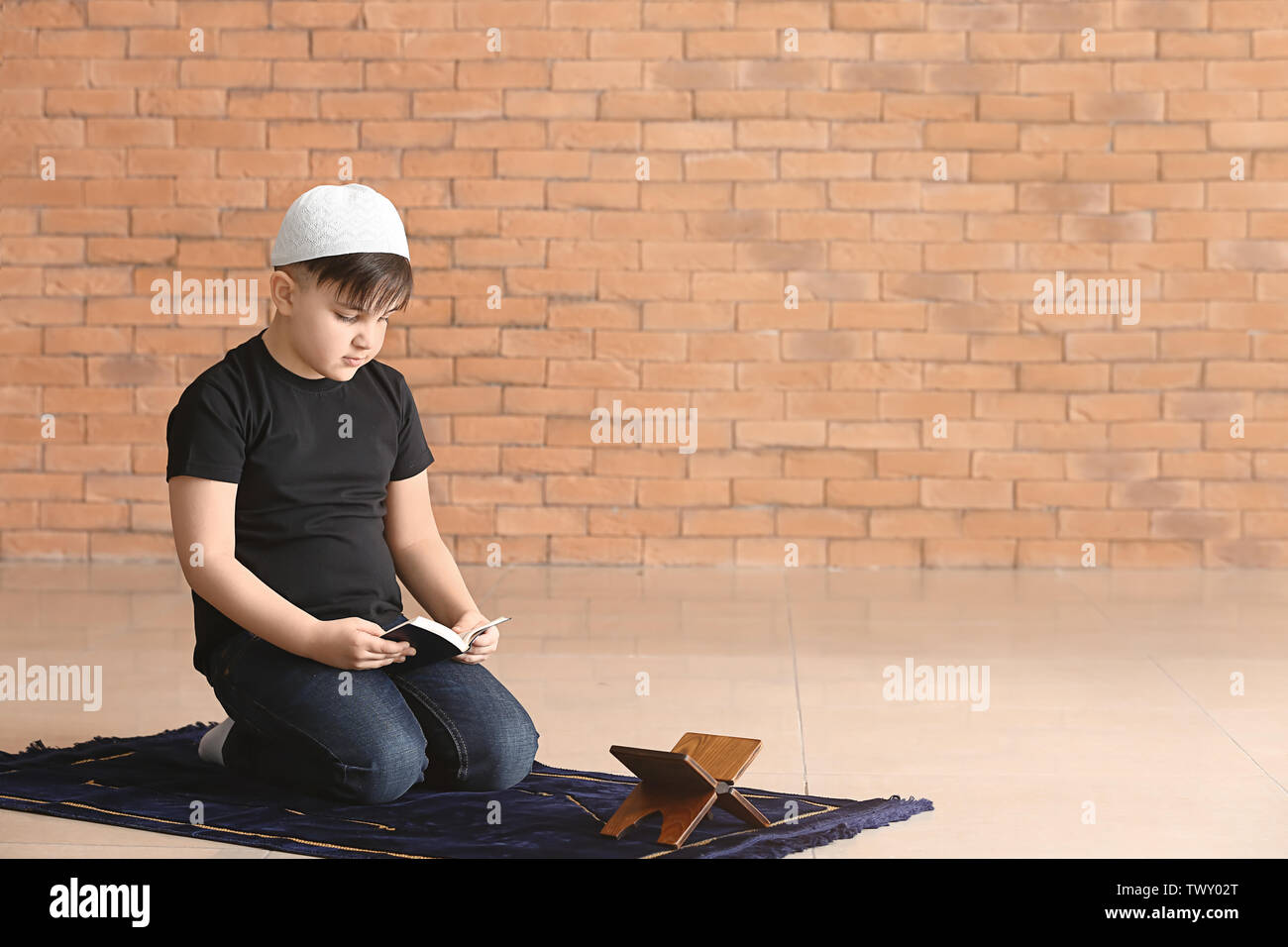Little Muslim boy praying indoors Stock Photo - Alamy